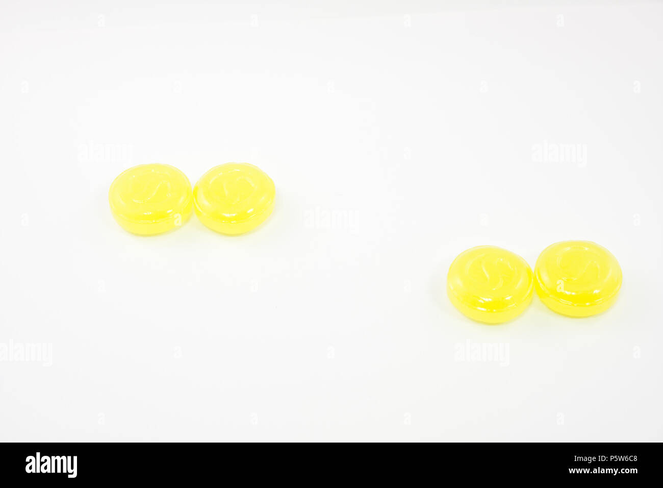 yellow cough sweets isolated on white background Stock Photo - Alamy