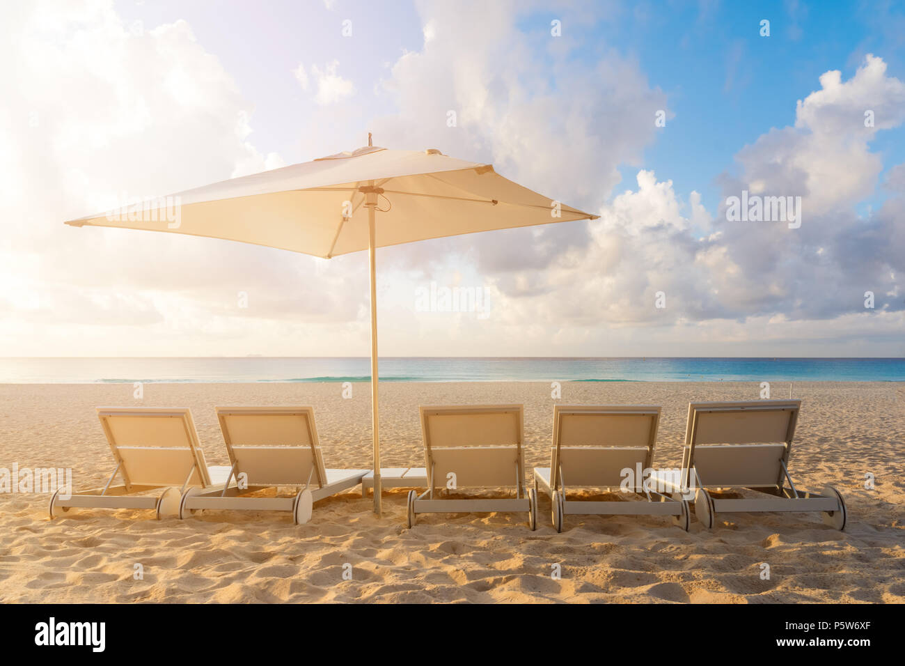 Five Beach chairs and Umbrella on the white sand beach with cloudy blue ...