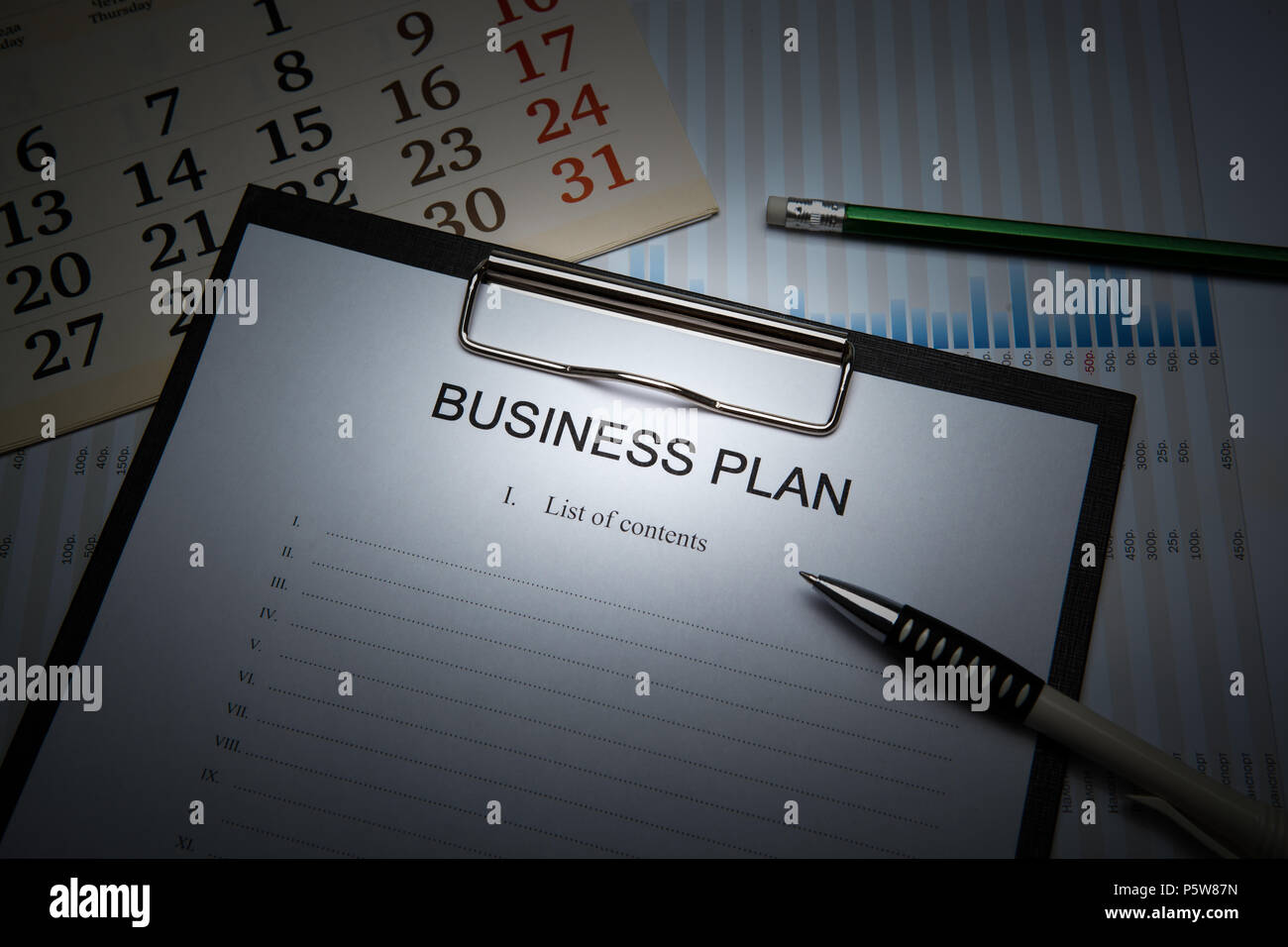 Document with title business plan and office supplies Stock Photo - Alamy