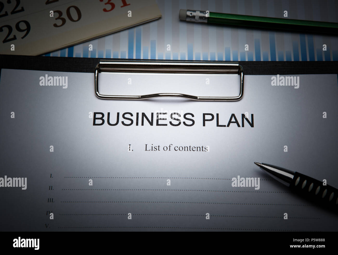 Document with title business plan and office supplies Stock Photo - Alamy