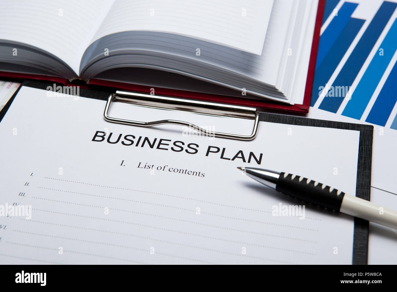 Document with title business plan and office supplies Stock Photo - Alamy