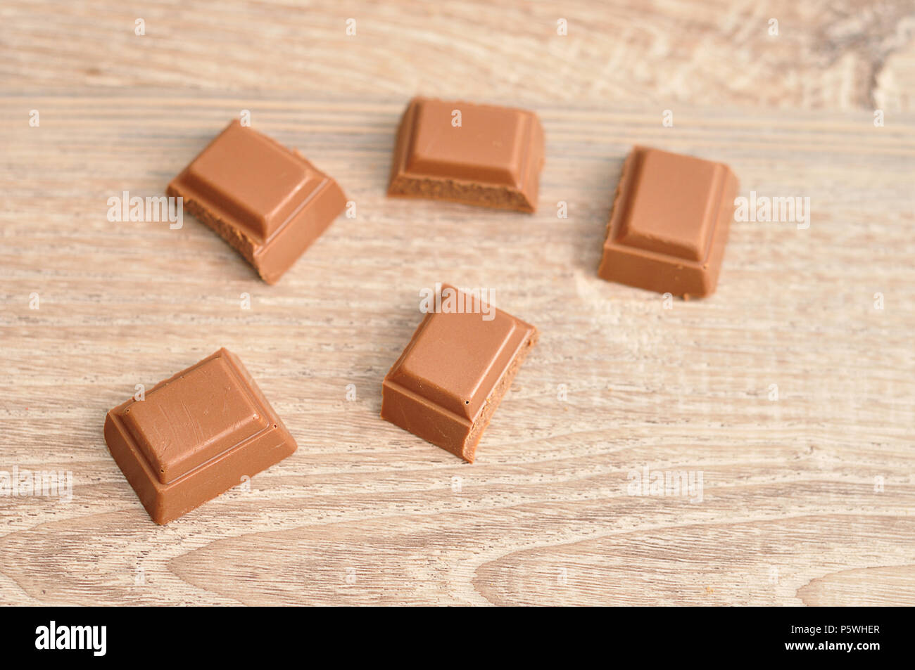 A chocolate candy bar broken into pieces Stock Photo - Alamy