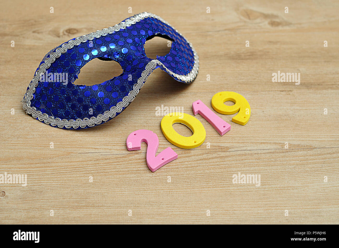 A blue masquerade mask with 2019 in colorful numbers Stock Photo - Alamy