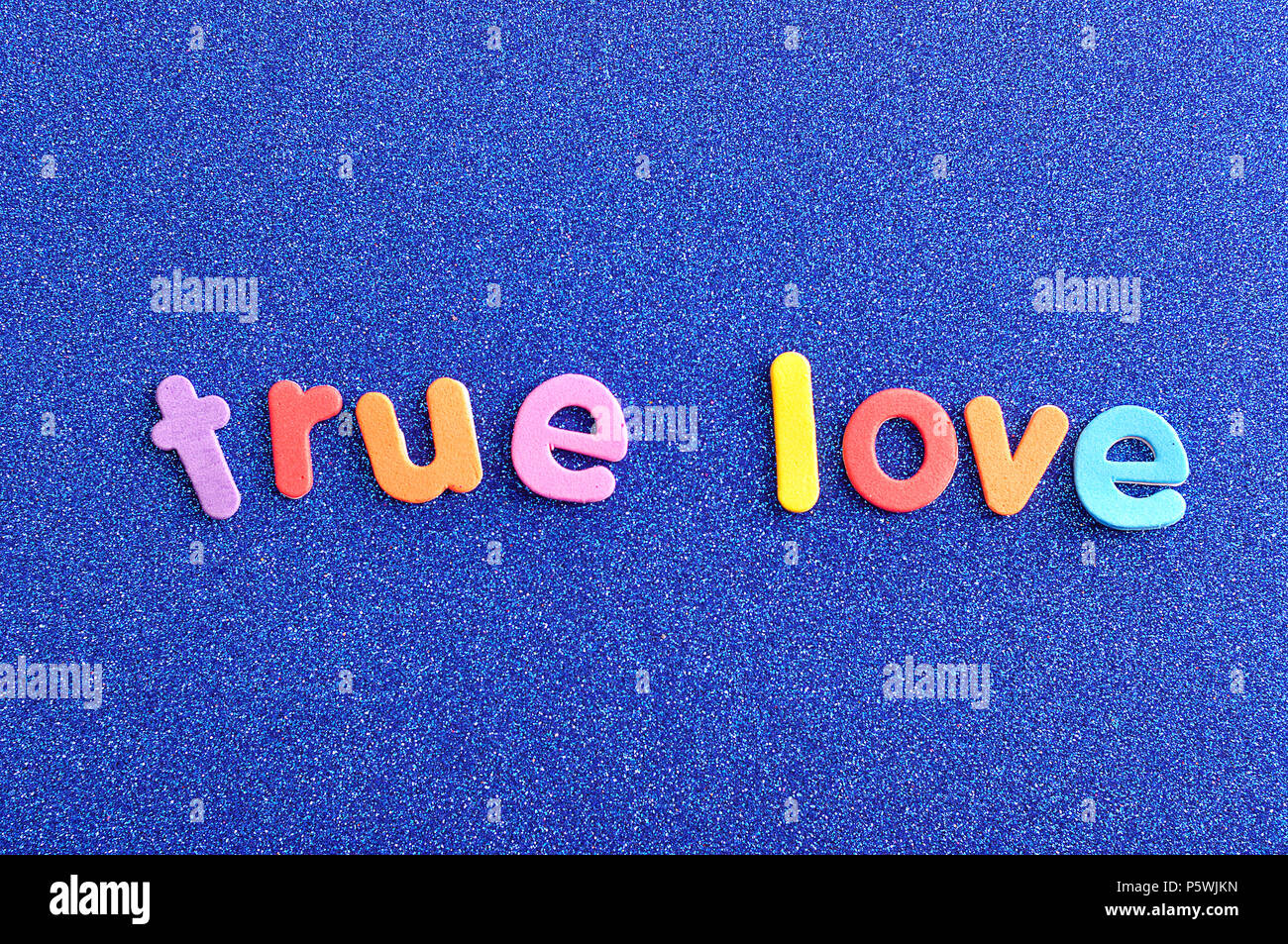 The words true love in colorful letters on a blue background Stock ...