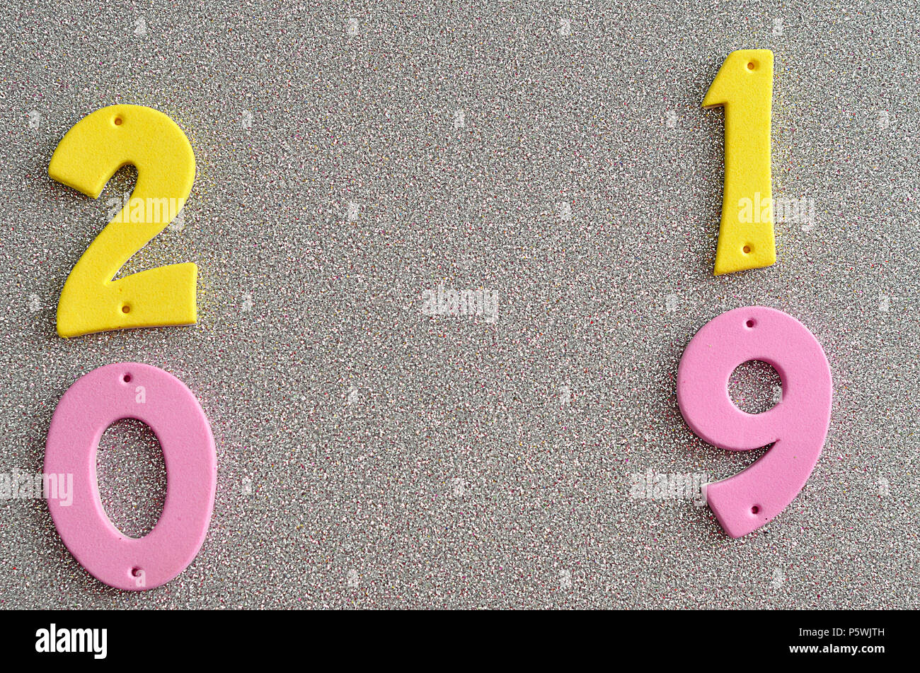 2019 in pink and yellow numbers on a silver background Stock Photo - Alamy