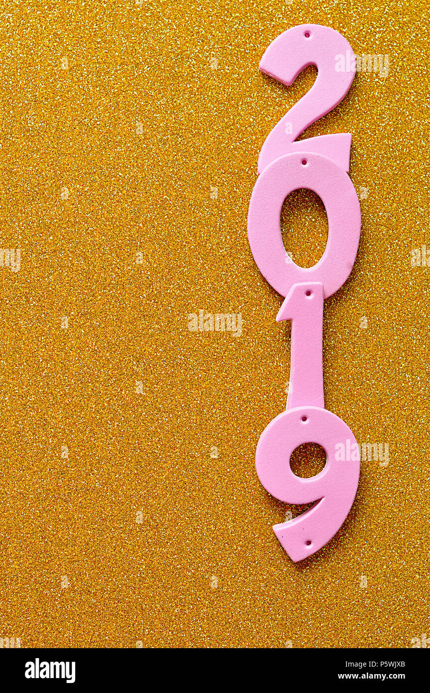 2019 in pink numbers on a gold background Stock Photo - Alamy
