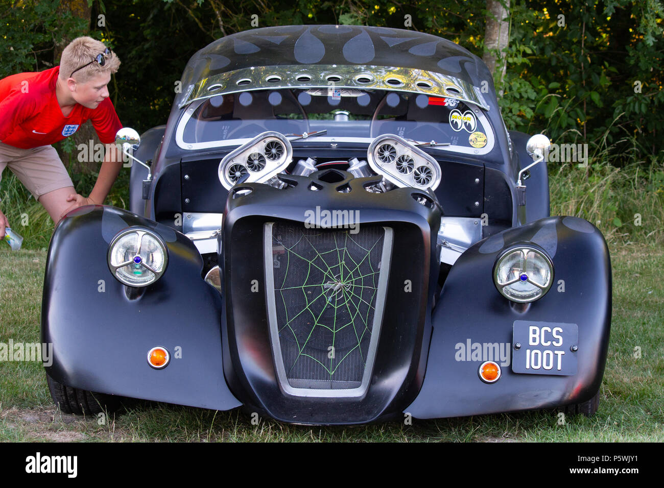 A kit car made in the style of a bat car on show at a classic car show ...