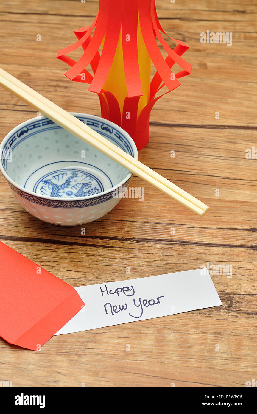 A homemade lantern display with a pair of chopsticks, a bowl and a red ...