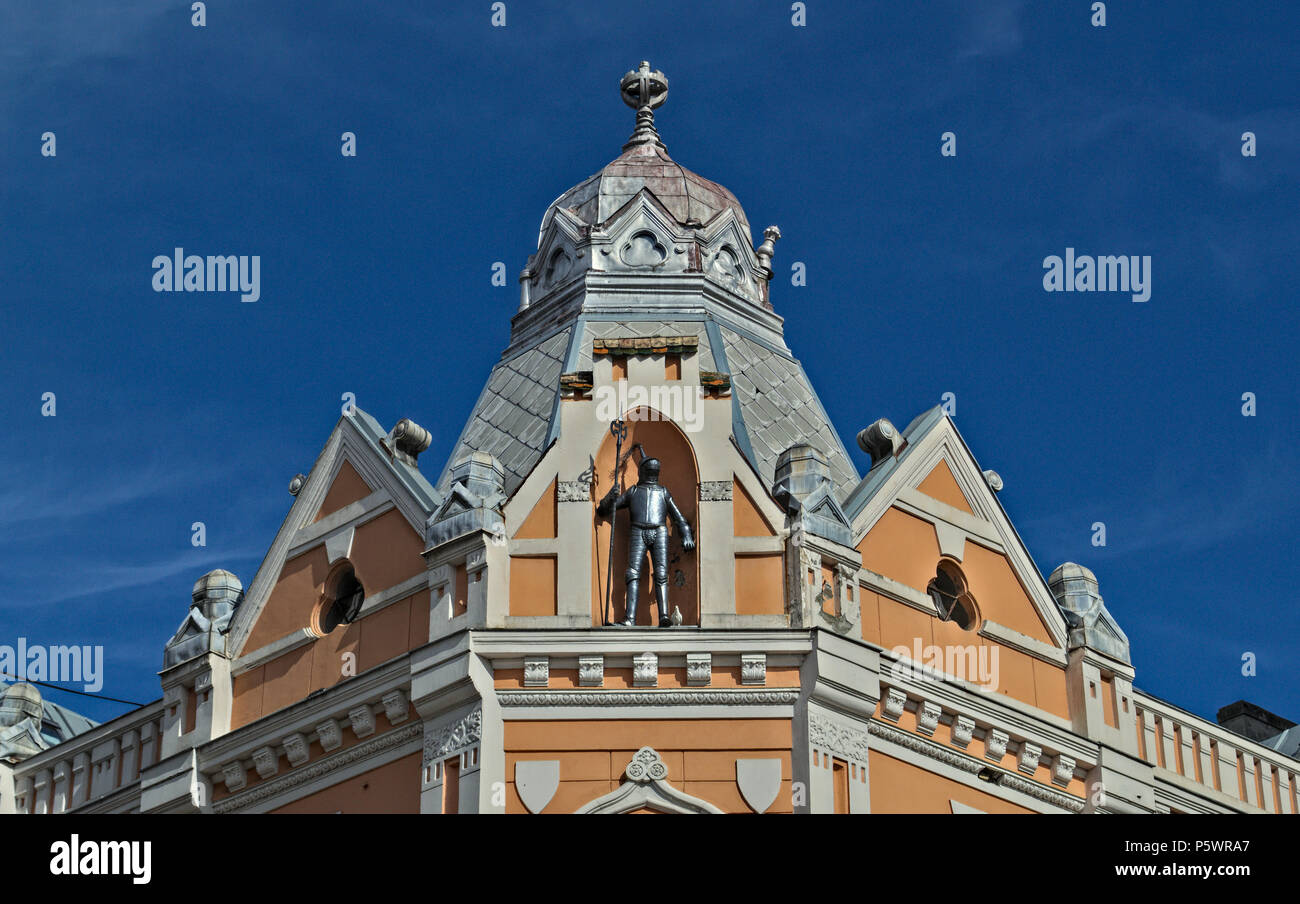 Top of old 19th century restored building with a knight armor in the ...