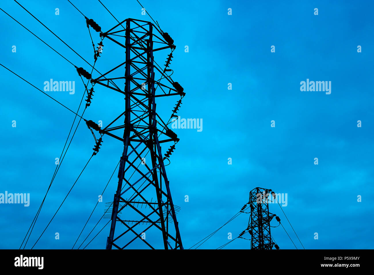 an image of a metal tower of Power Lines Stock Photo - Alamy