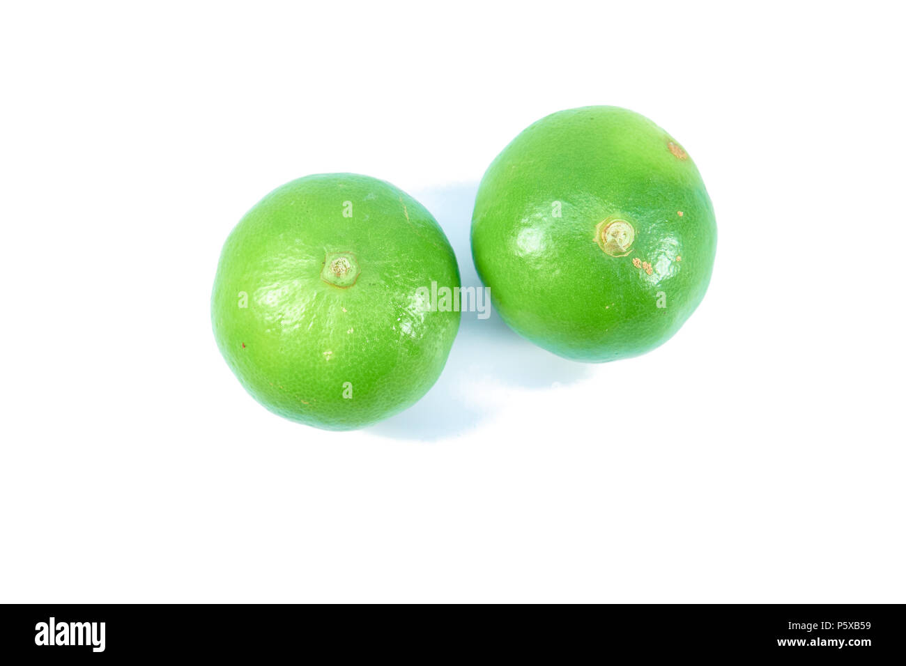 Two green lemons Cut Out Stock Images & Pictures - Alamy