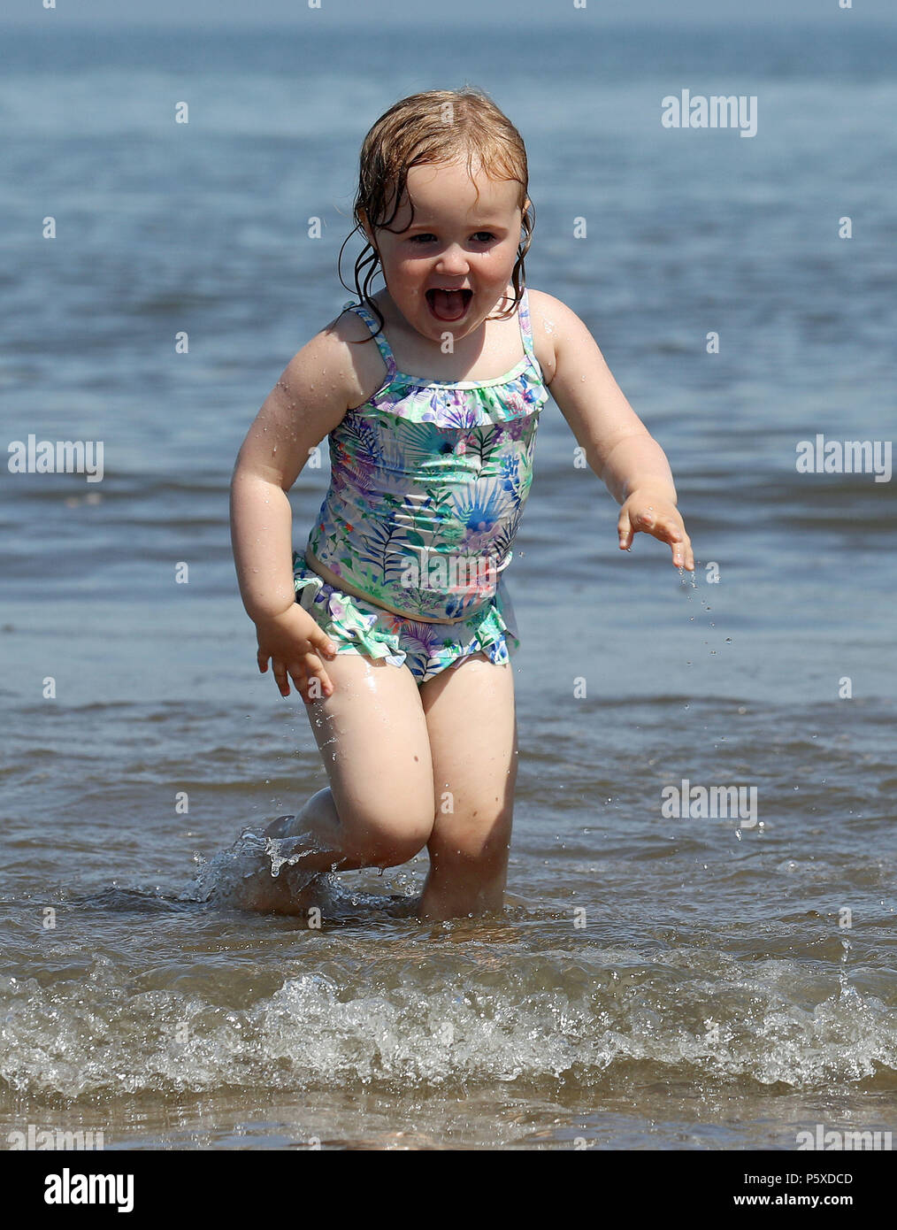 Harley Murray, aged 3, enjoys her first dip in the sea at Portobello ...