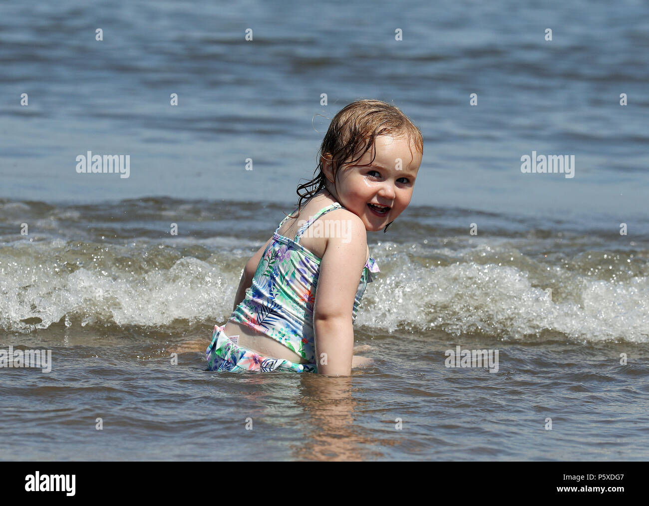 Harley Murray, aged 3, enjoys her first dip in the sea at Portobello ...