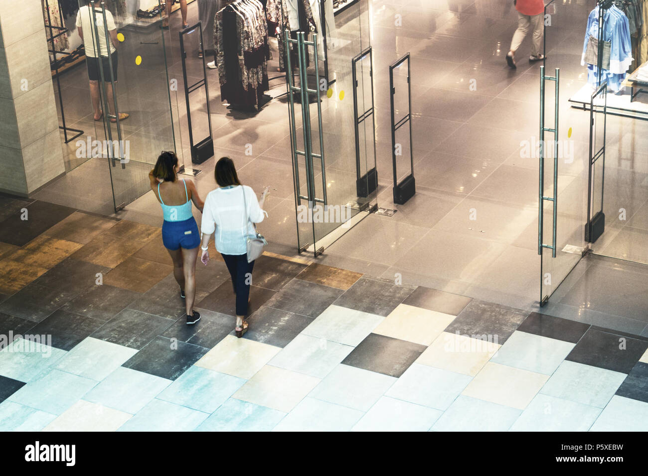 Silhouettes of Two Women Goes to the Clothing Store. View from Above in ...