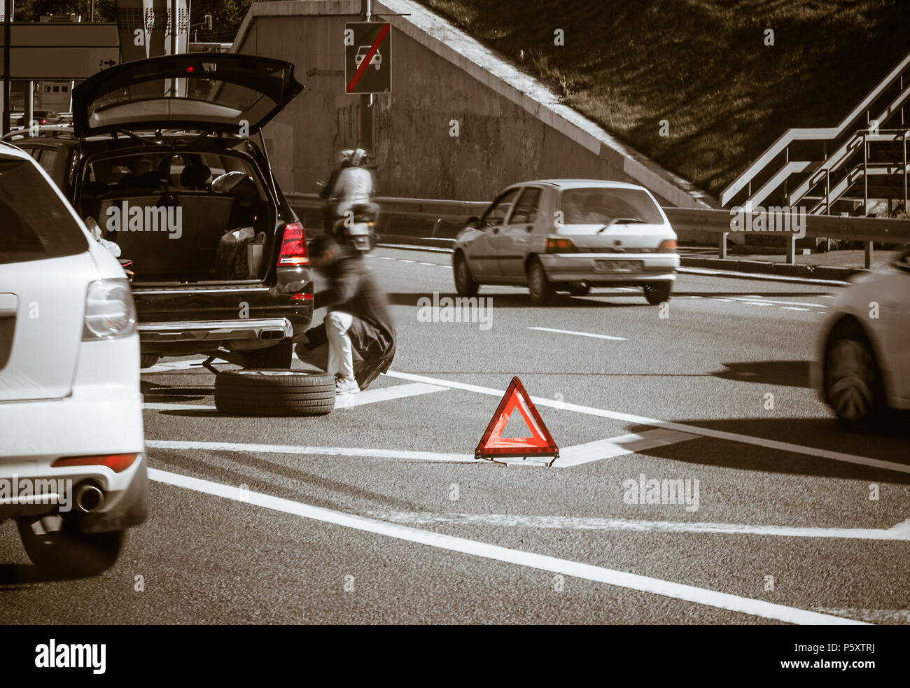 fitting wheel among traffic Stock Photo - Alamy