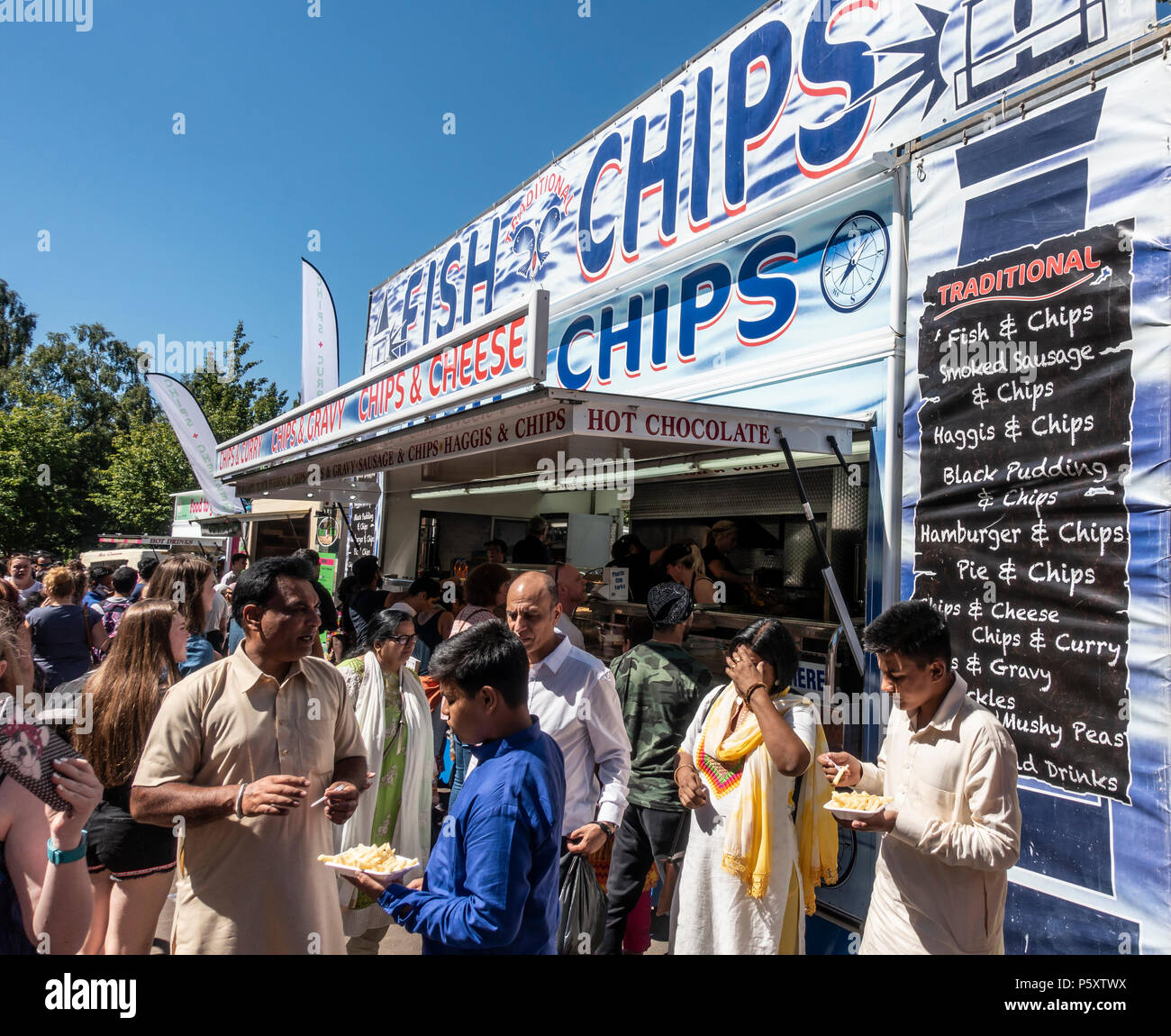 Multi-ethic crowd at a traditional fish and chip fast food stand at ...