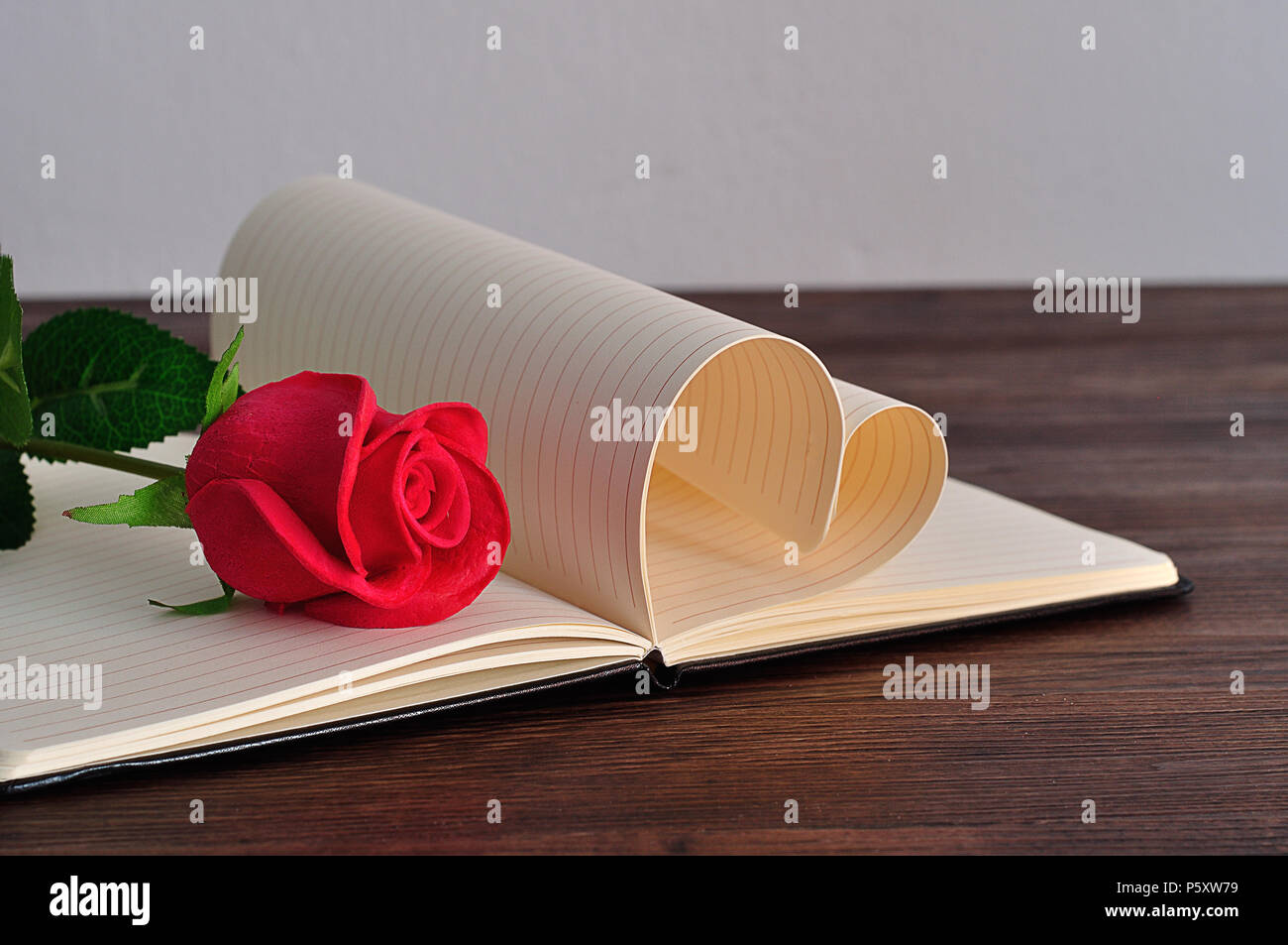 Open book heart pages flower hi-res stock photography and images - Alamy