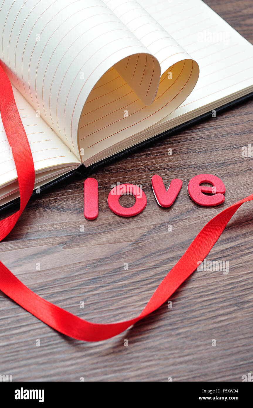 Open book with red ribbon hi-res stock photography and images - Alamy