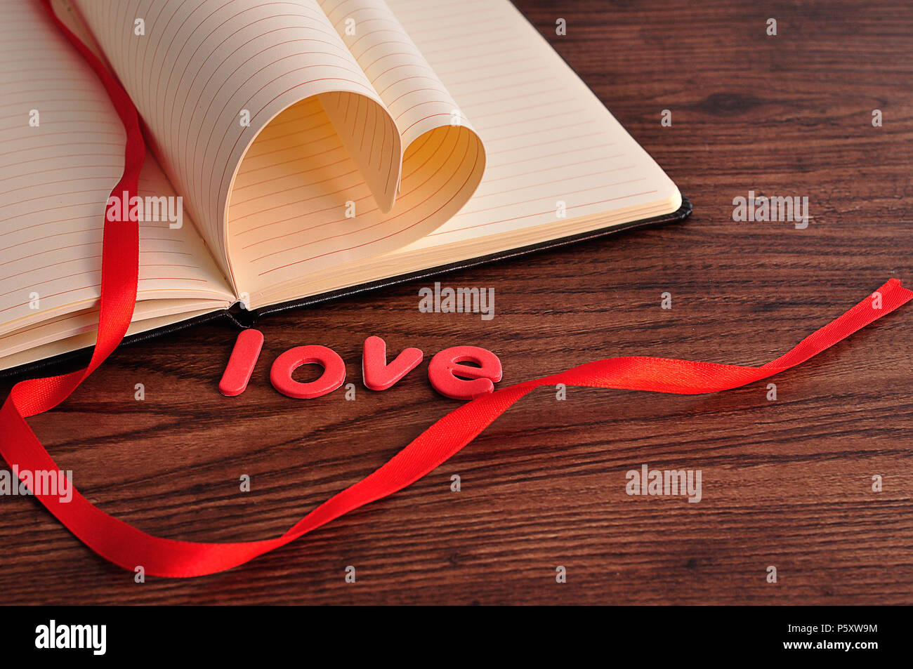 Open book with red ribbon hi-res stock photography and images - Alamy
