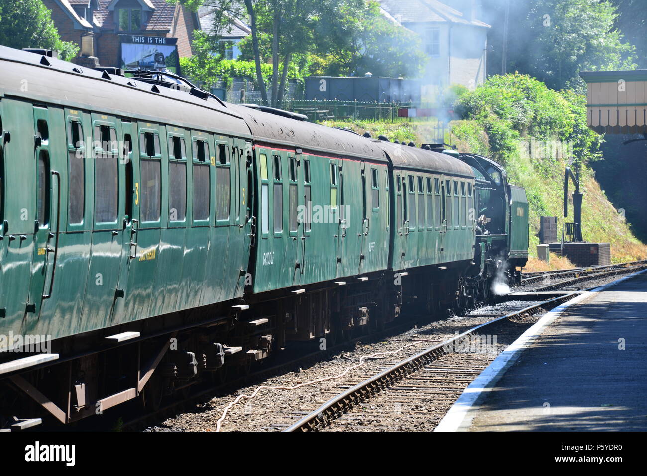 A steam passenger train waiting at a station in the UK Stock Photo - Alamy