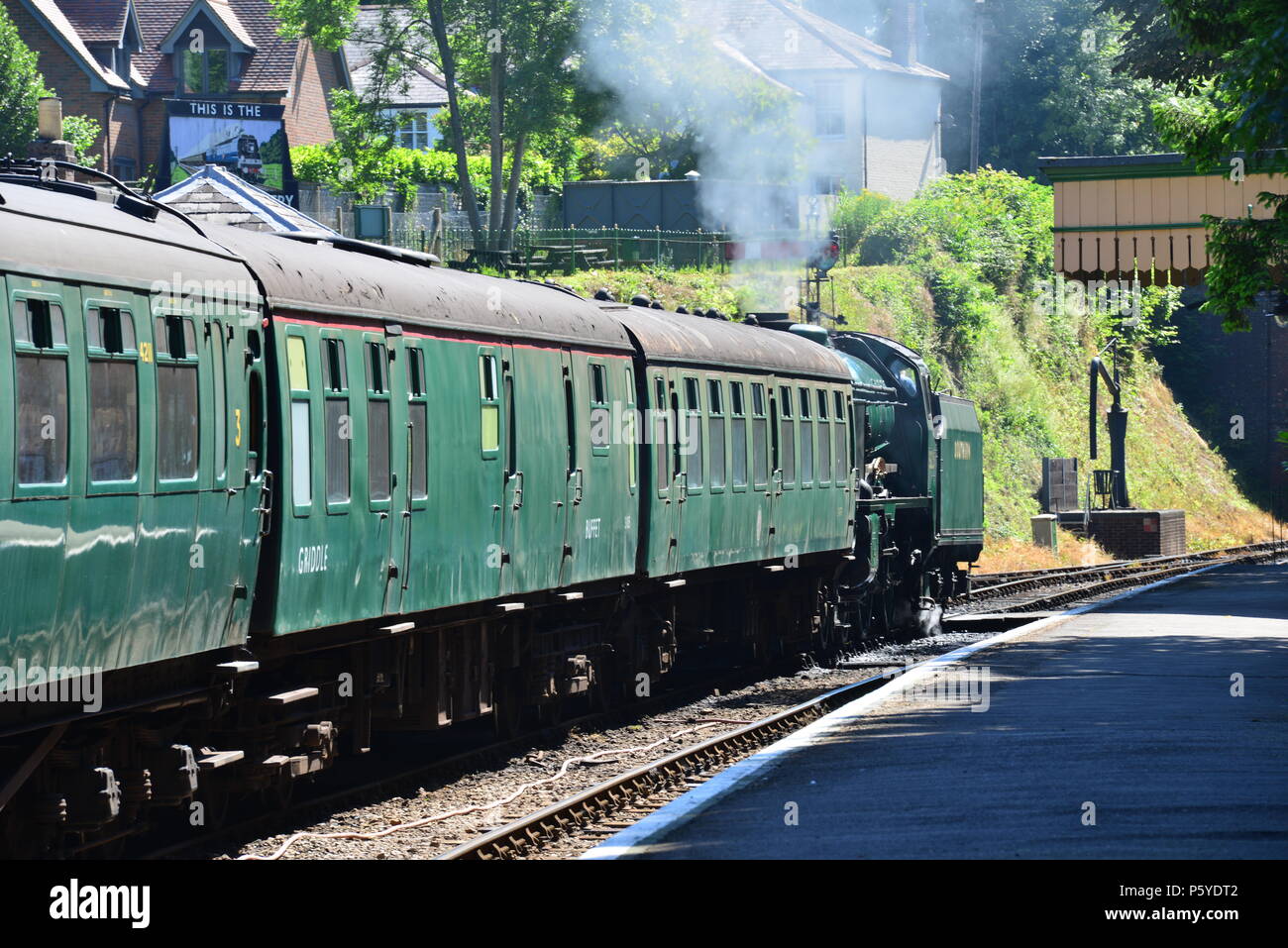 A steam passenger train waiting at a station in the UK Stock Photo - Alamy