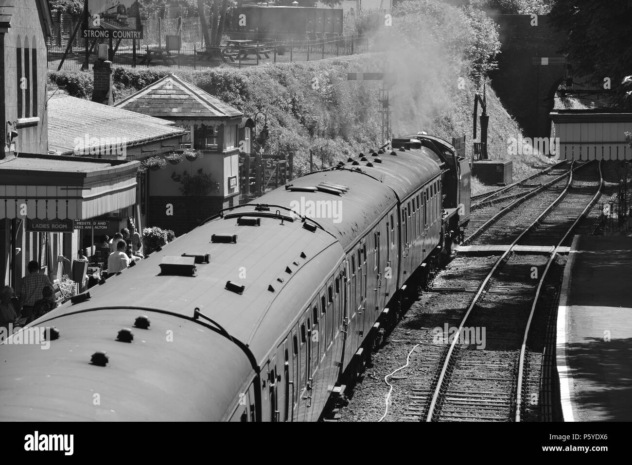 A steam passenger train waiting at a station in the UK Stock Photo - Alamy