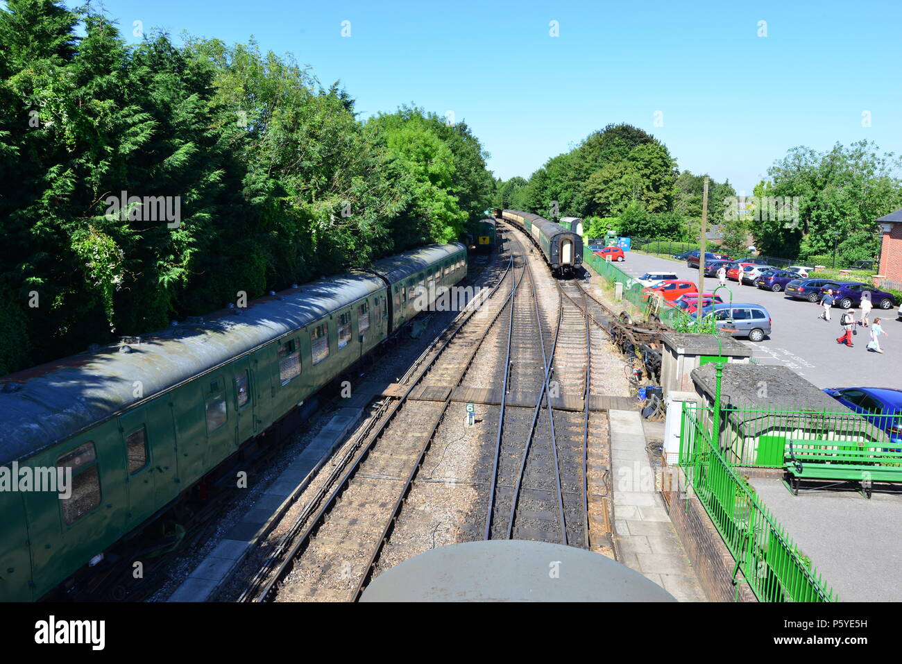 Coaches waiting to connect to a steam train at the rear of a station ...