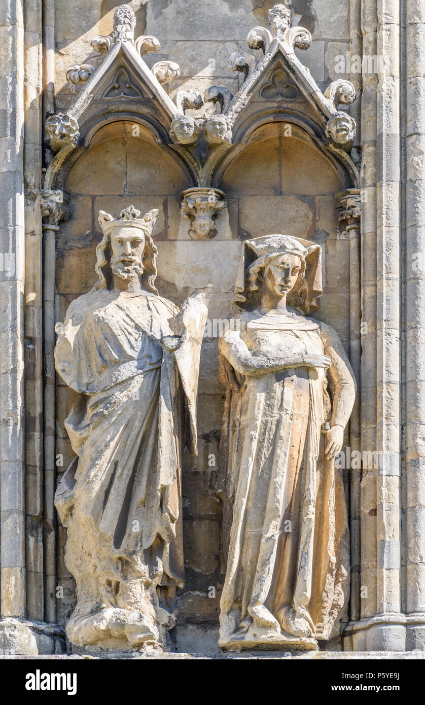 Weathered statue in a niche on the south exterior wall, of a king and ...
