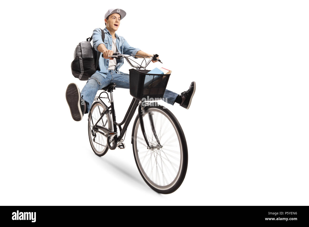 Joyful teenage boy with a backpack riding a bicycle isolated on white ...