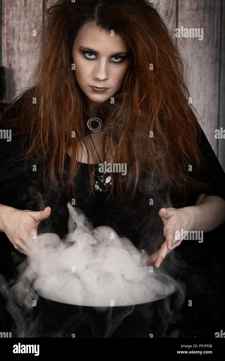 portrait of witch with magic smoking cauldron Stock Photo - Alamy