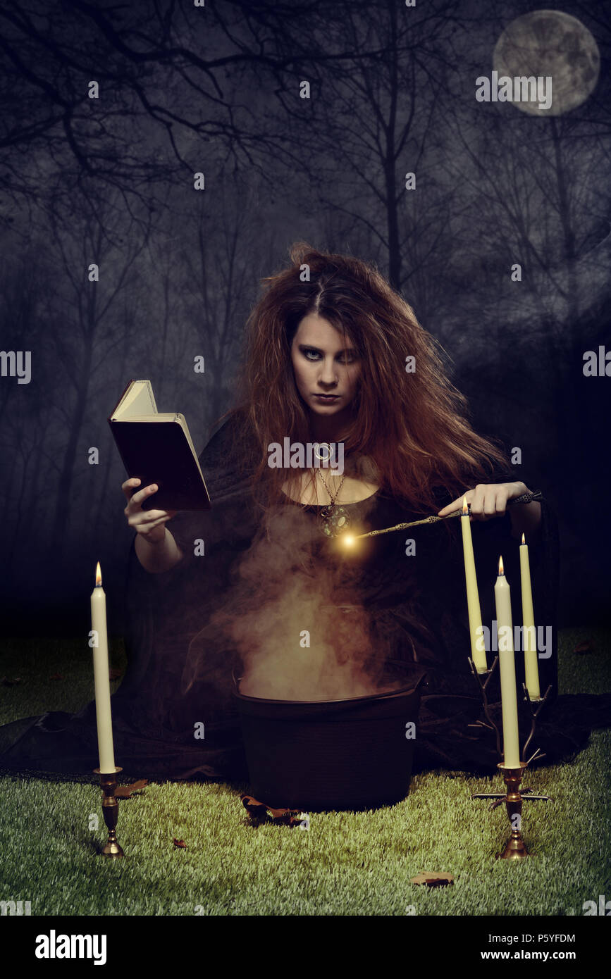 witch at night using magic with wand Stock Photo - Alamy