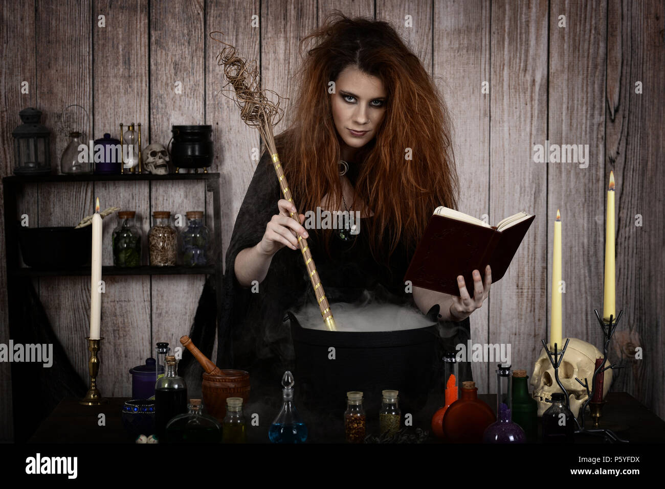 witch in her cottage making a magic potion Stock Photo - Alamy