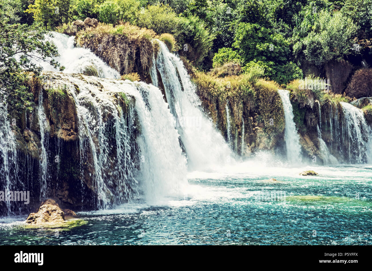 Krka waterfalls. Croatian national park. Beautiful natural scene. Flowing water and greenery ...