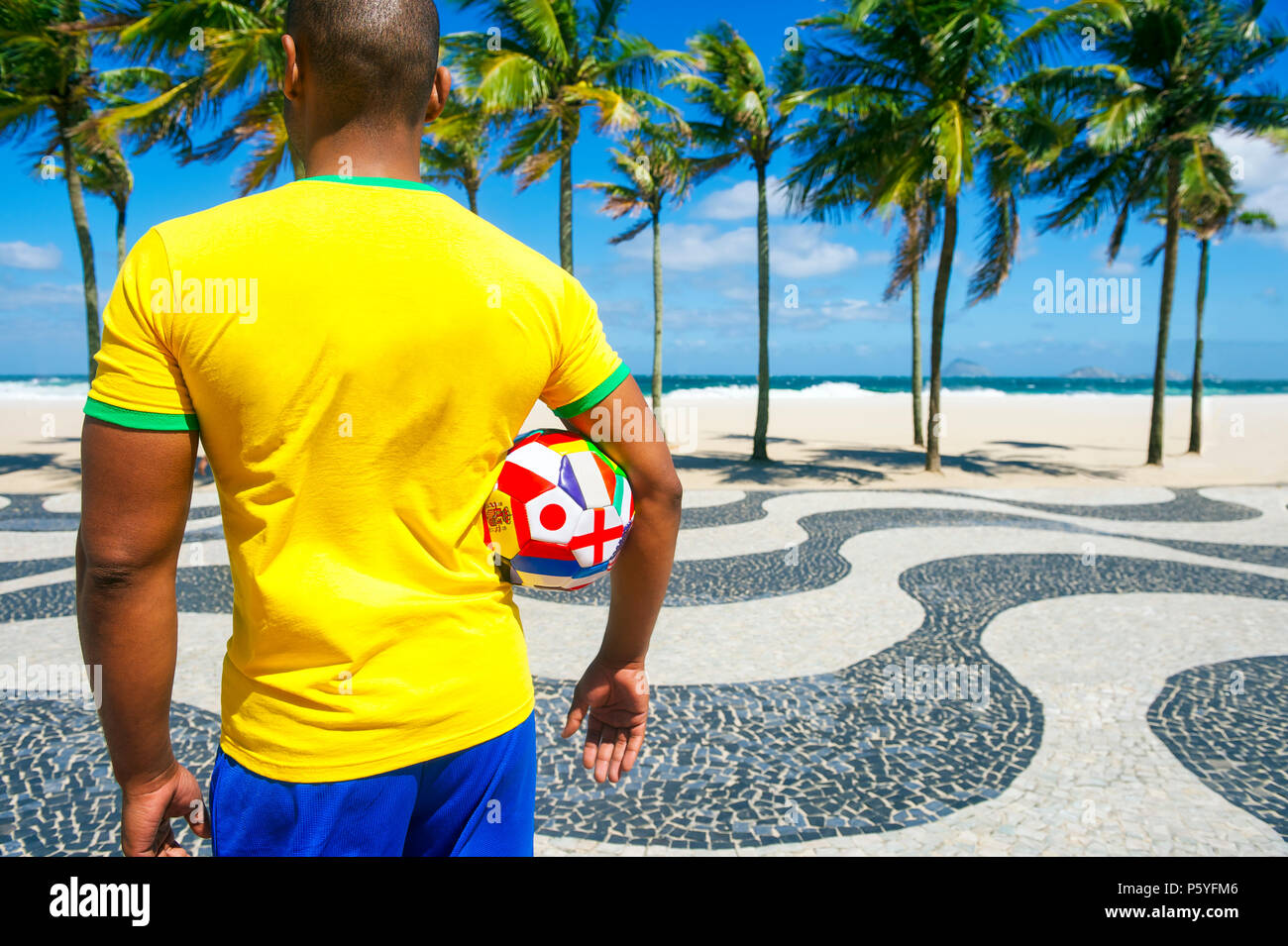 Brazilian football player yellow shirt holding international flag ...