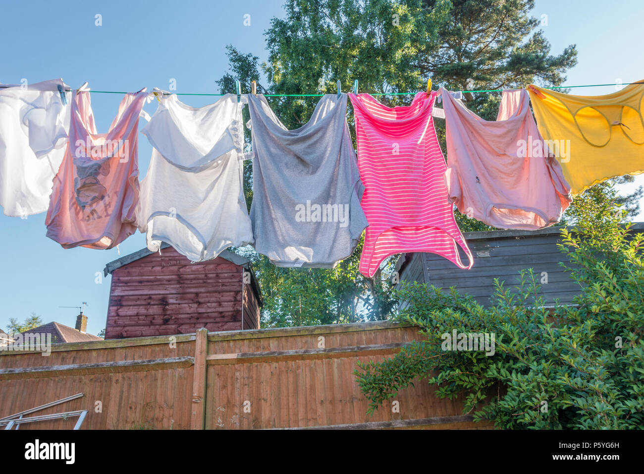Clothes hanging on a washing line in a residential garden to dry Stock ...