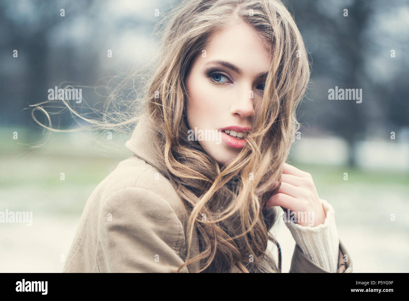 Beautiful model walking in park, outdoors portrait Stock Photo - Alamy