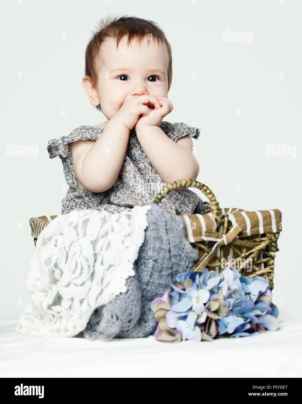 Happy baby girl with flowers. Cute little child Stock Photo - Alamy