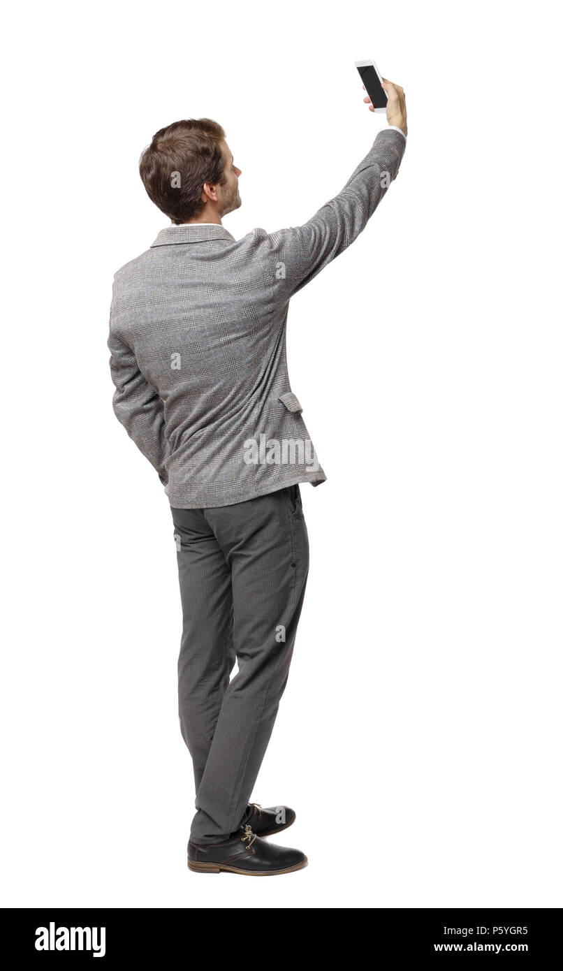 Back view of a businessman in a suit making a selfie. rear view people ...