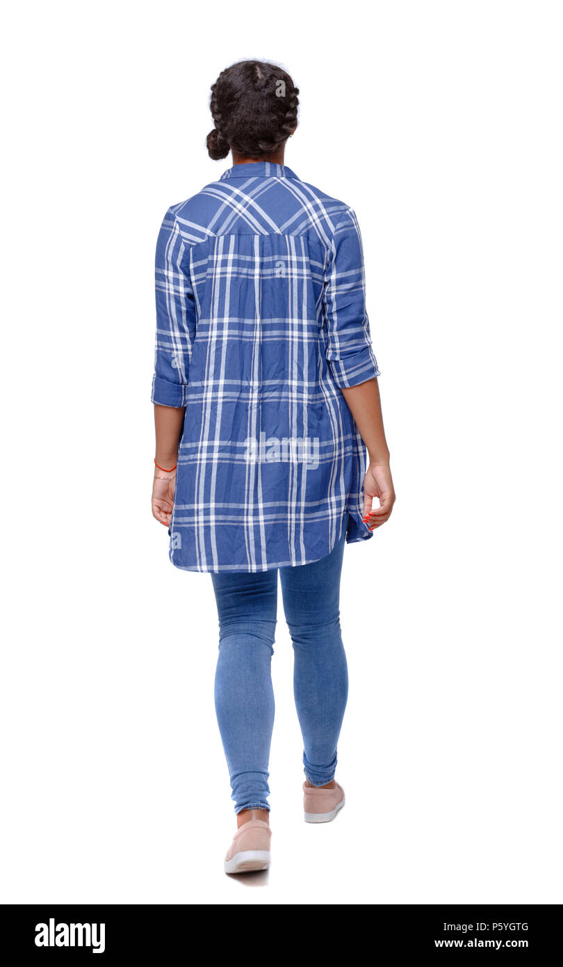 back view of a young black girl walking in jeans and a checkered shirt ...