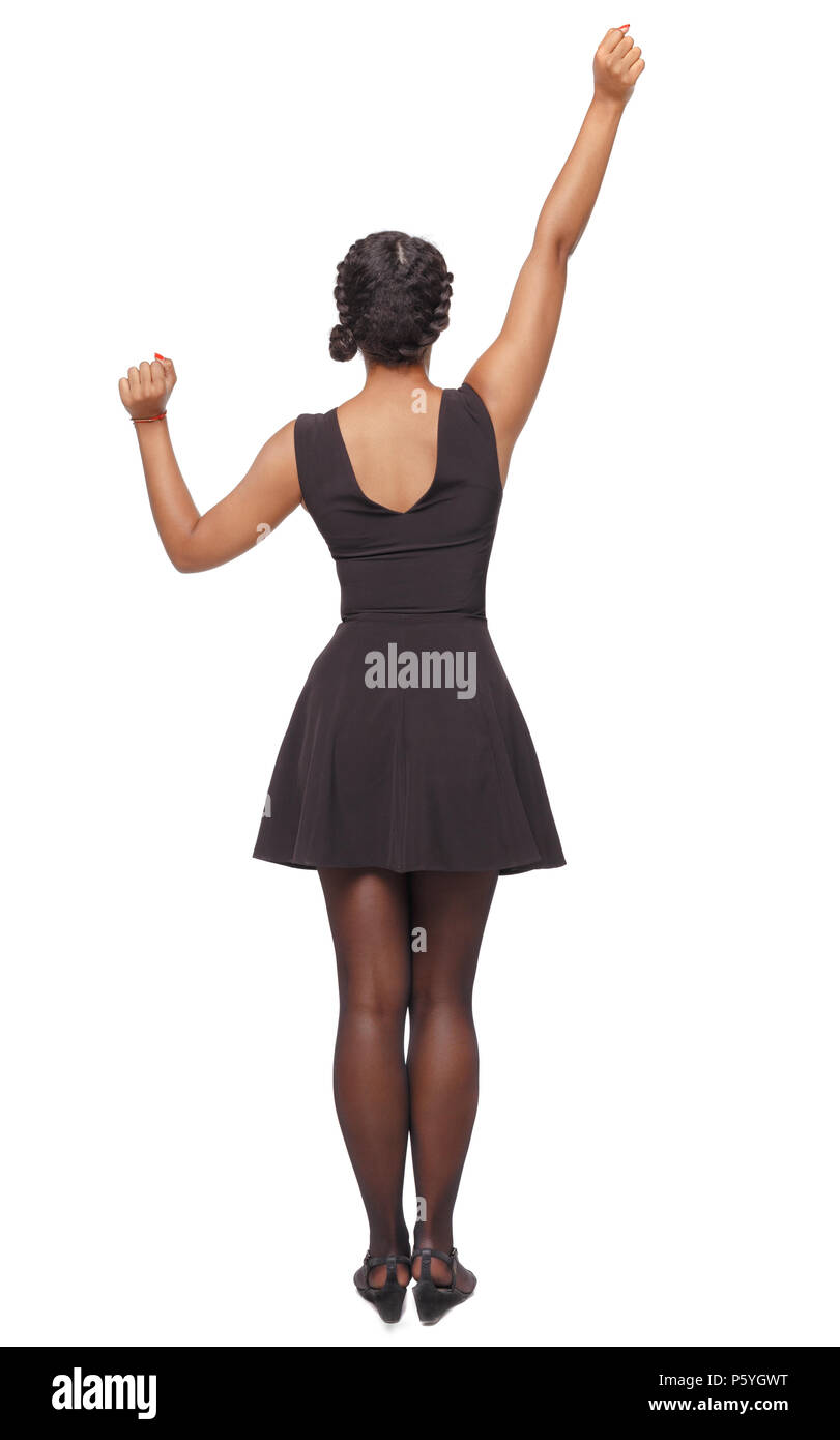 Back view of a black woman in dress who dances. girl watching. Rear ...
