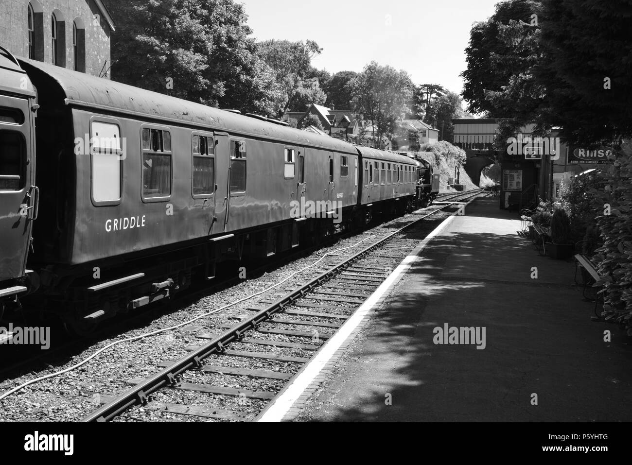 A steam train pulling coaches waiting to depart from a station Stock ...