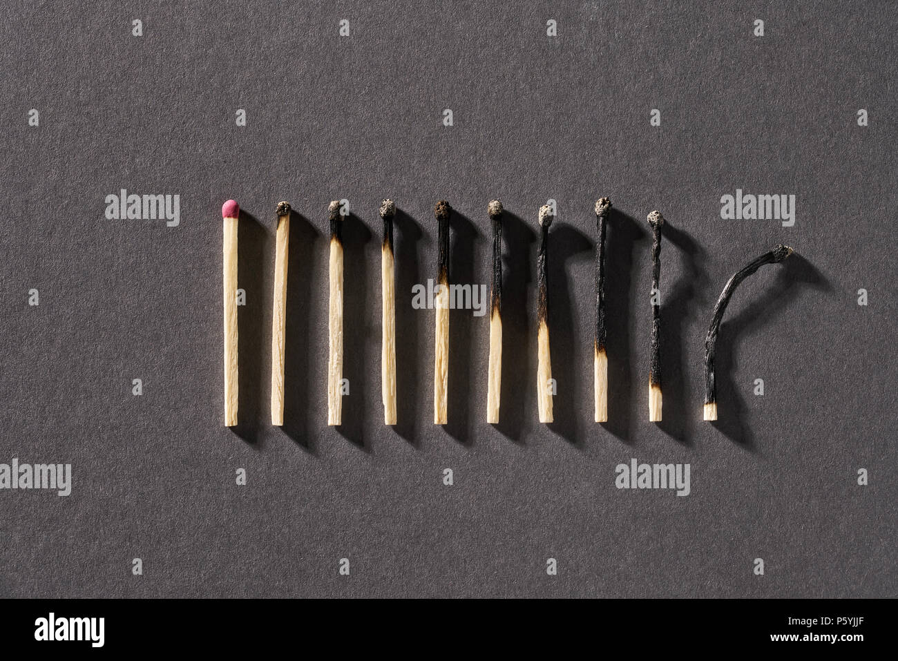 Burnt matchsticks on background in studio Stock Photo - Alamy