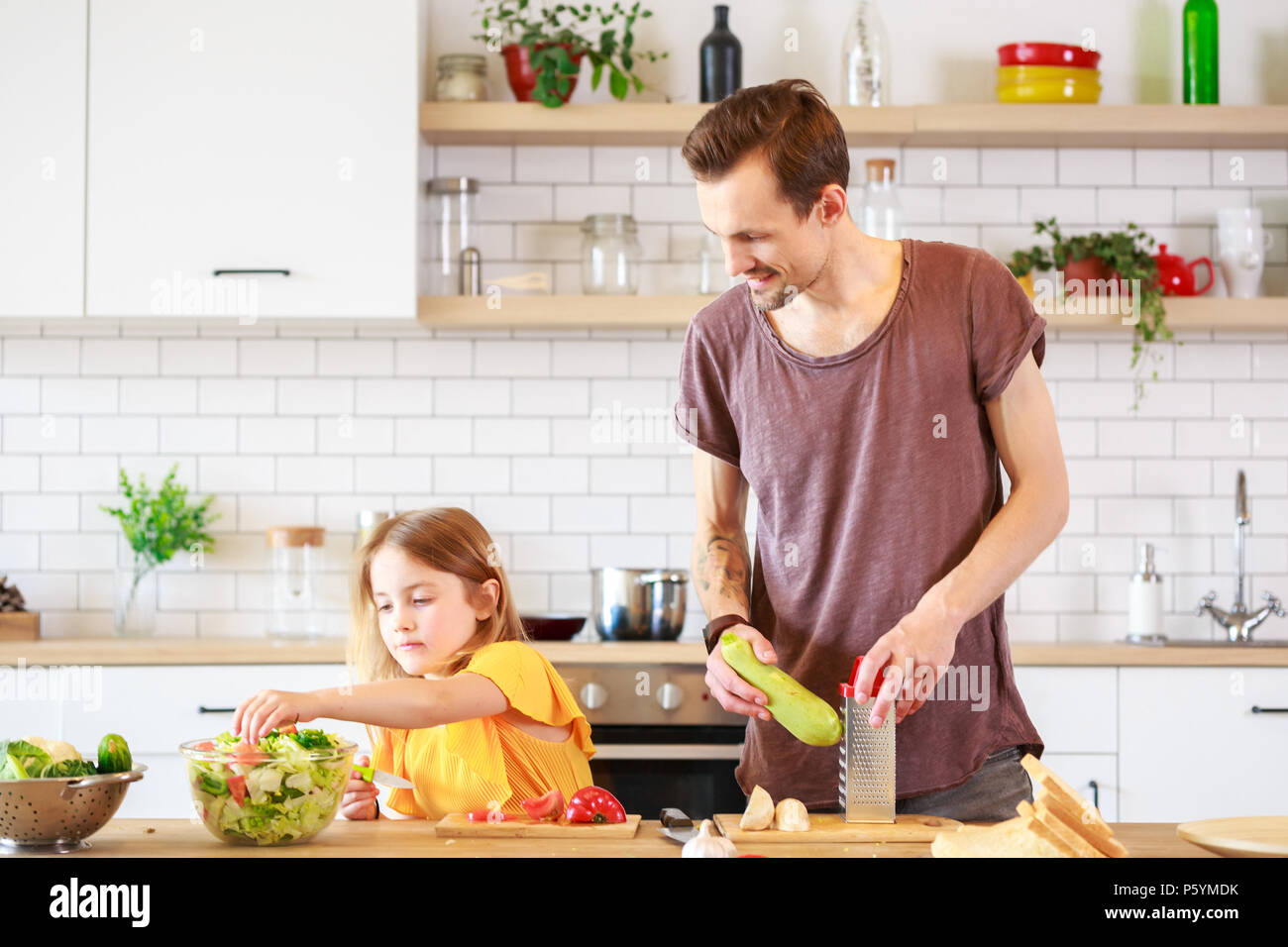 Photo of man with his daughter cooking dinner Stock Photo - Alamy