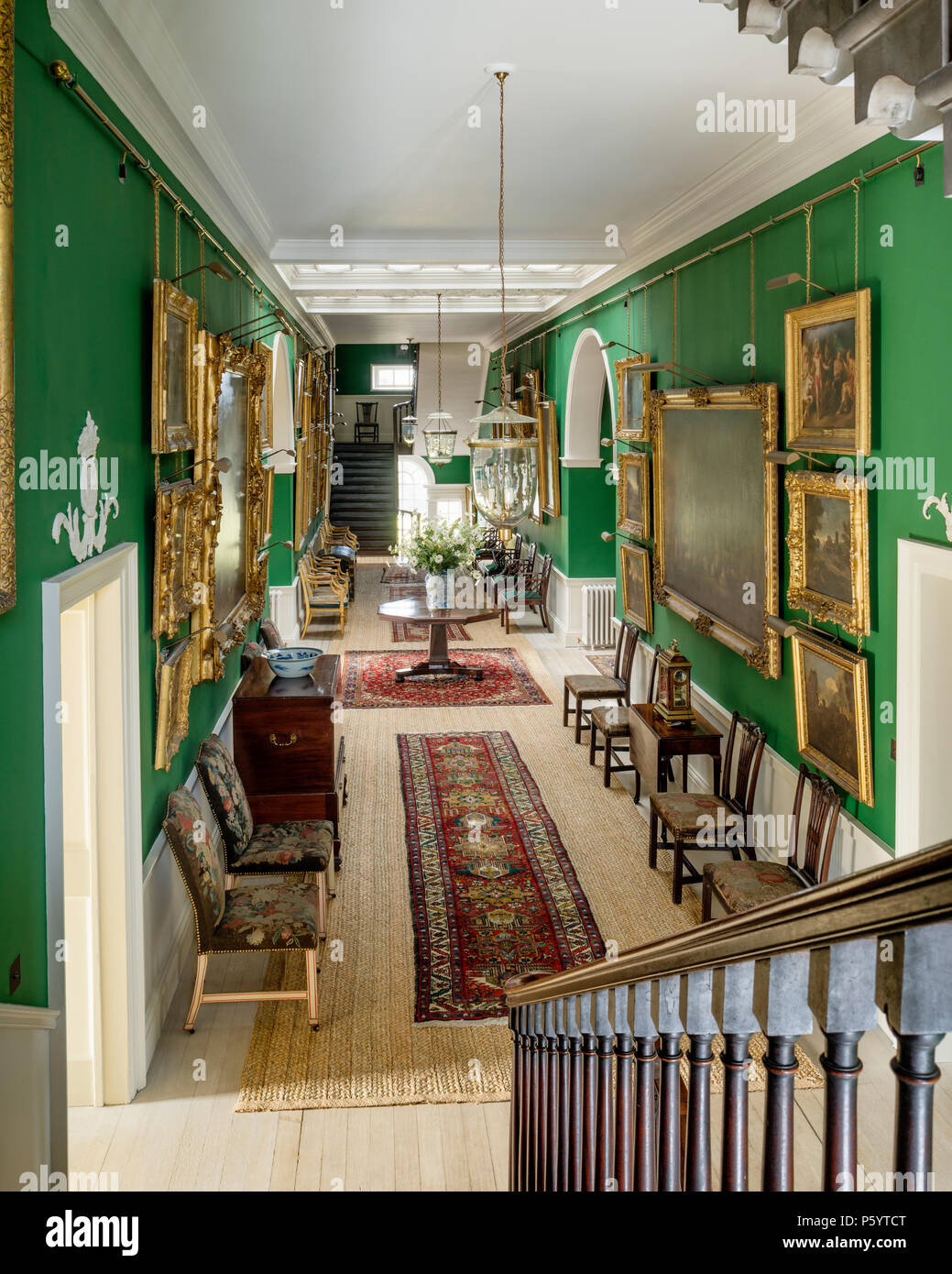 Paintings and chairs in Edwardian hallway Stock Photo - Alamy