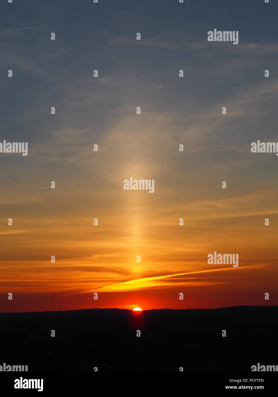Rare Sun Pillar cirrus cloud phenomenon above a vivid sunset over ...