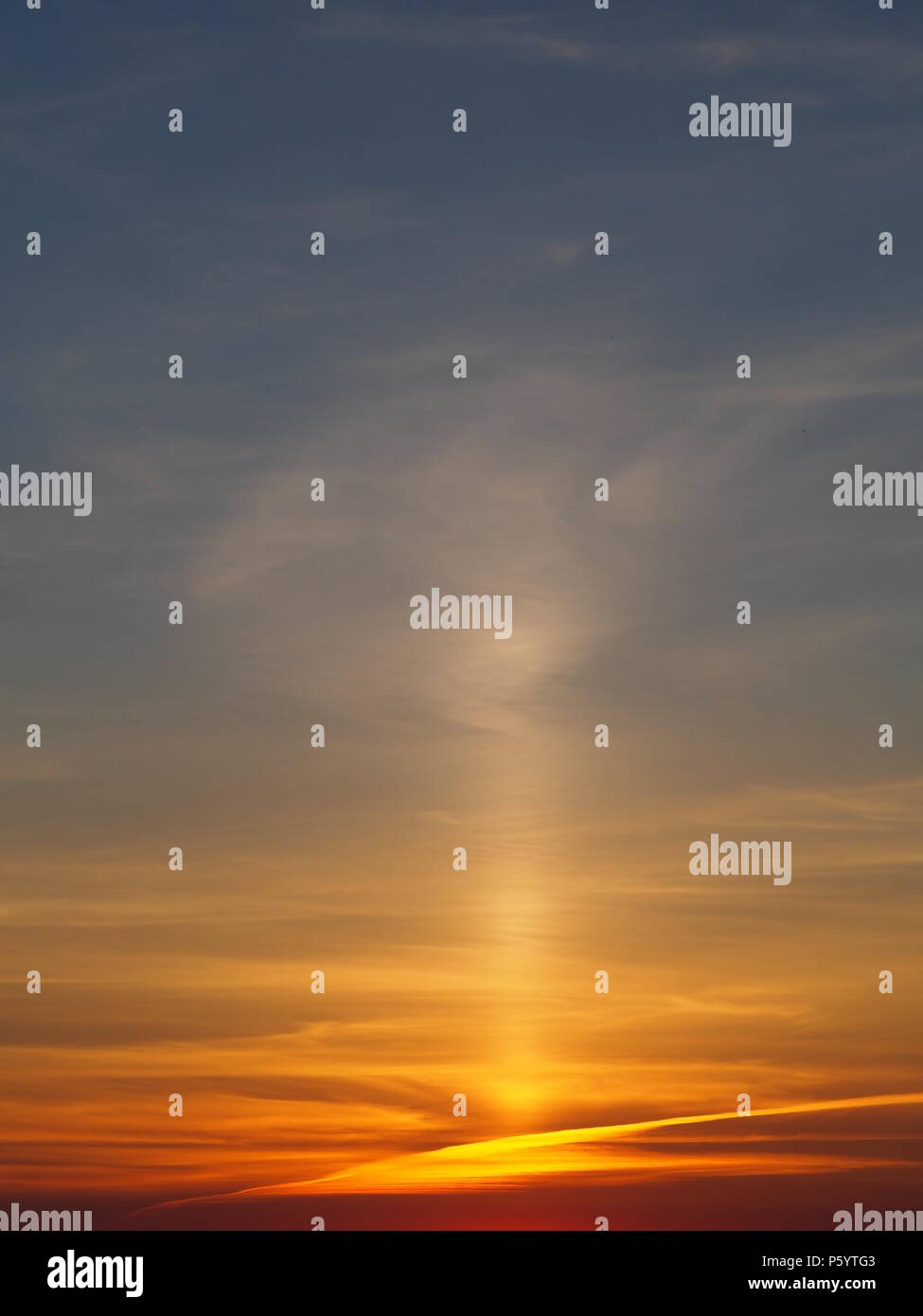 Rare Sun Pillar cirrus cloud phenomenon above a vivid sunset over ...