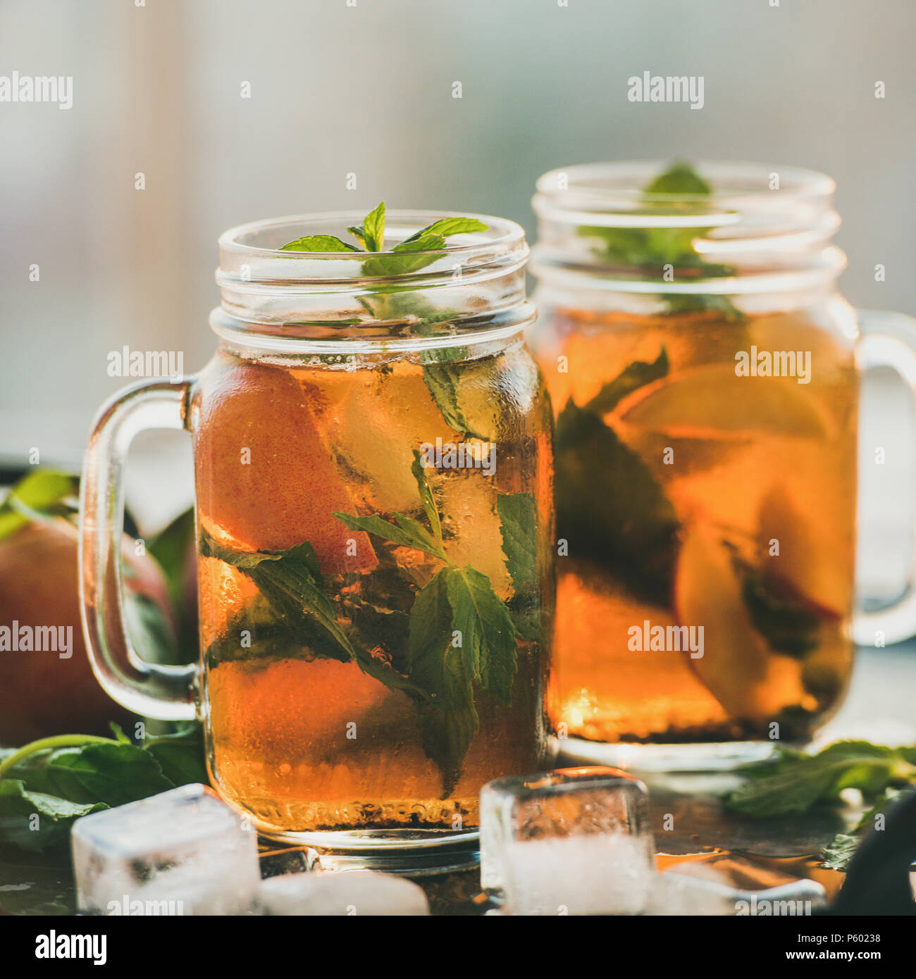 Summer refreshing cold peach ice tea on tray with ice Stock Photo - Alamy
