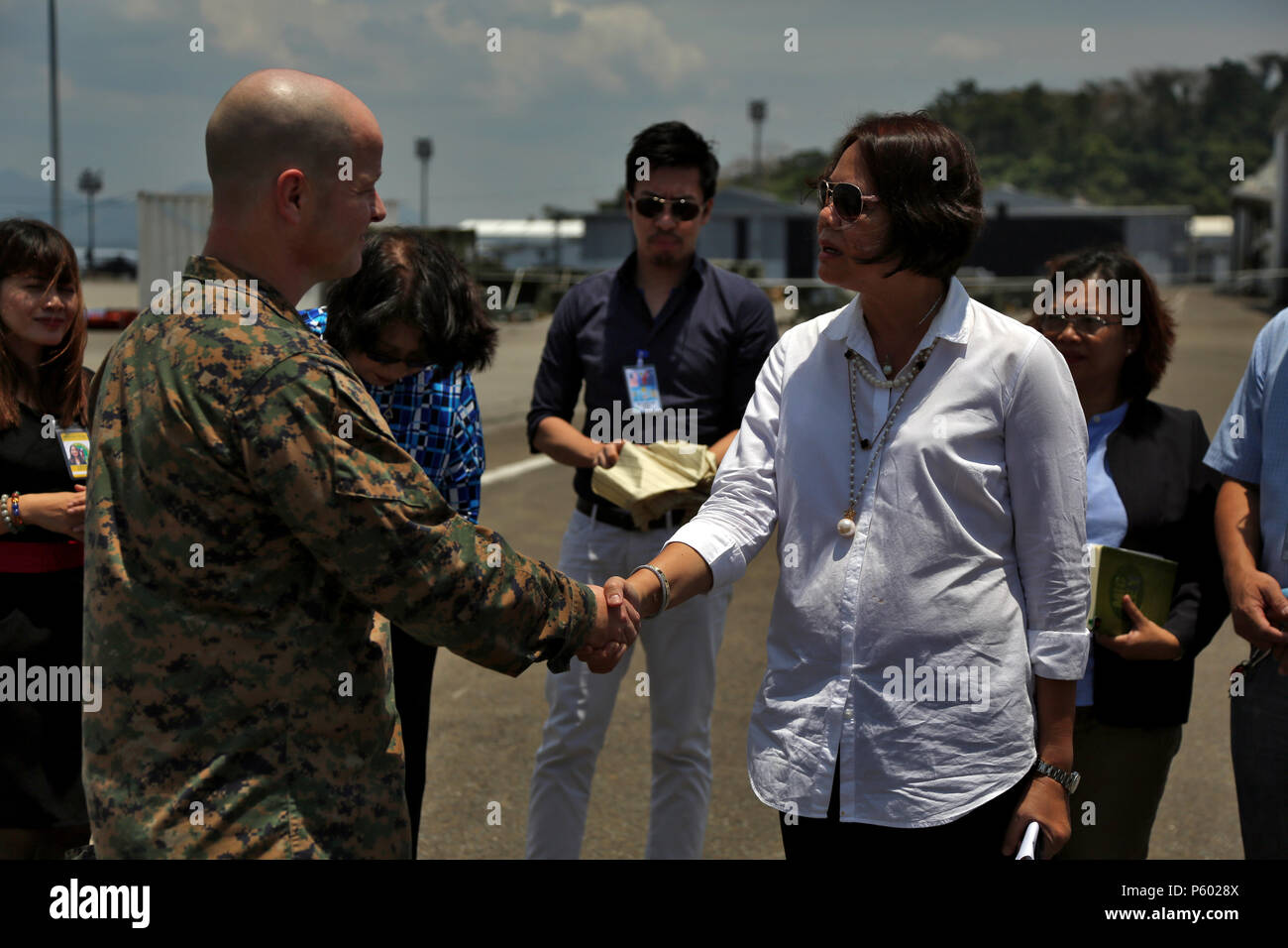 Navy Lt. Cmdr. Dean Goad speaks to Dr. Leonita P. Gorgolon, a director ...