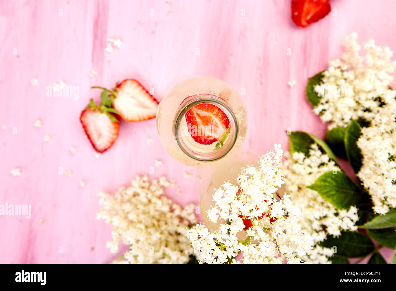 Kombucha tea with elderberry flower and strawberry on pink background ...
