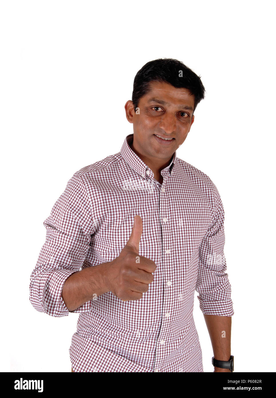 Happy looking man in a red checkered shirt standing and pointing with ...